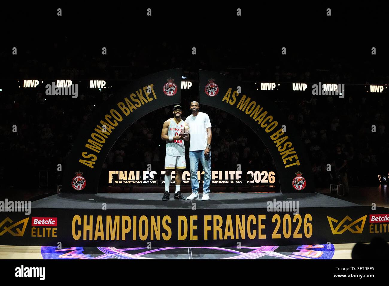 Elie OKOBO of Monaco receives finals map trophy from Nicholas BATUM ...