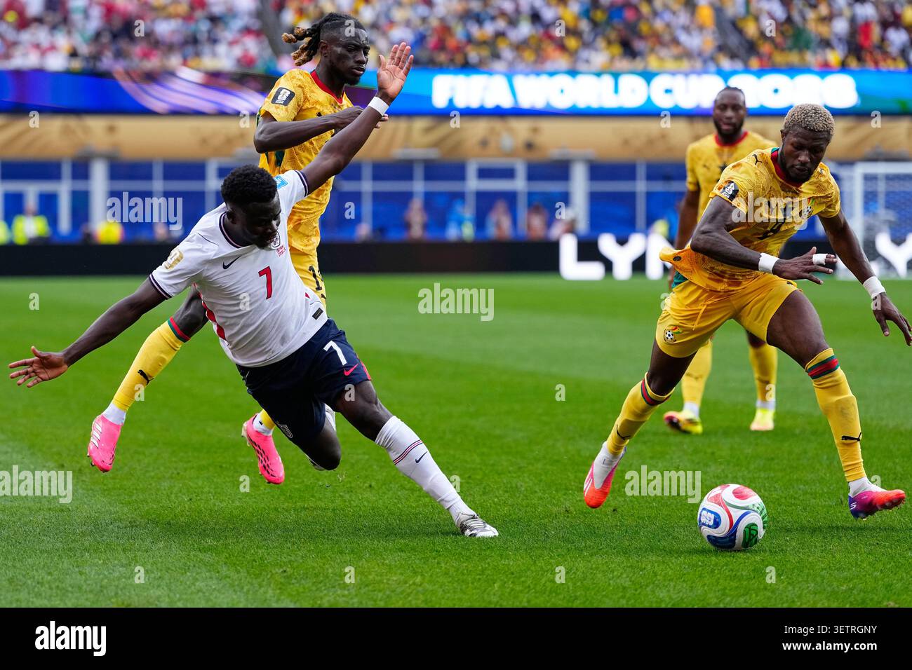 England's Bukayo Saka (7) and Ghana's Kwasi Sibo (8) go for the ball ...