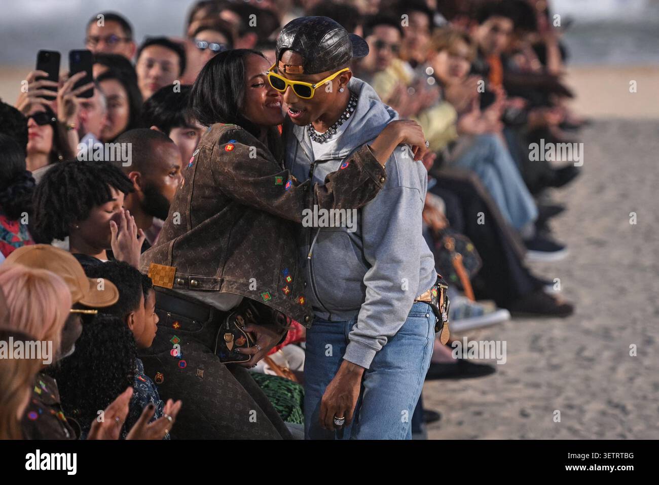 US designer Pharrell Williams cheers the attendees at the end of the ...