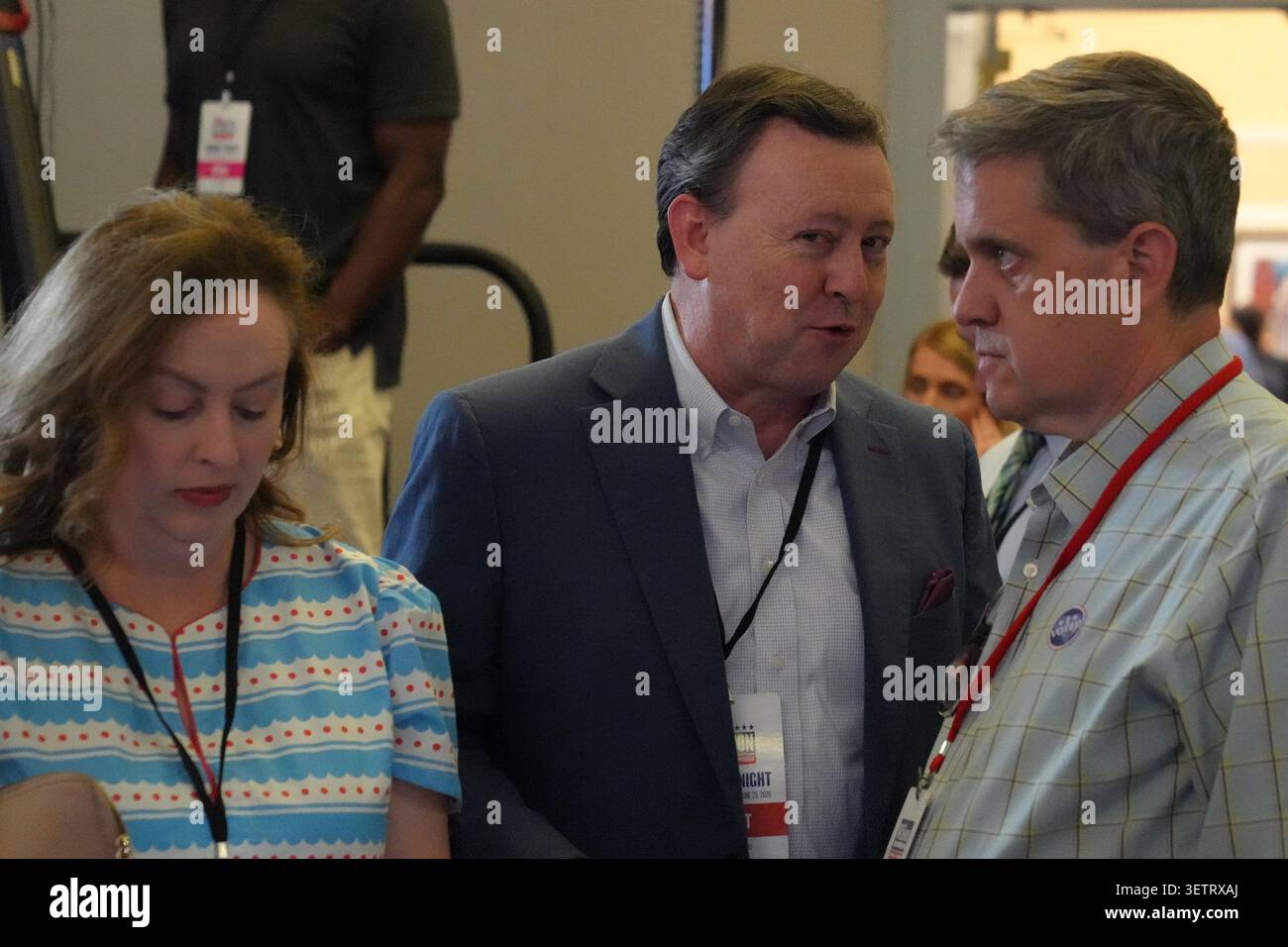 South Carolina GOP Chairman Drew McKissick, center, speaks with another ...