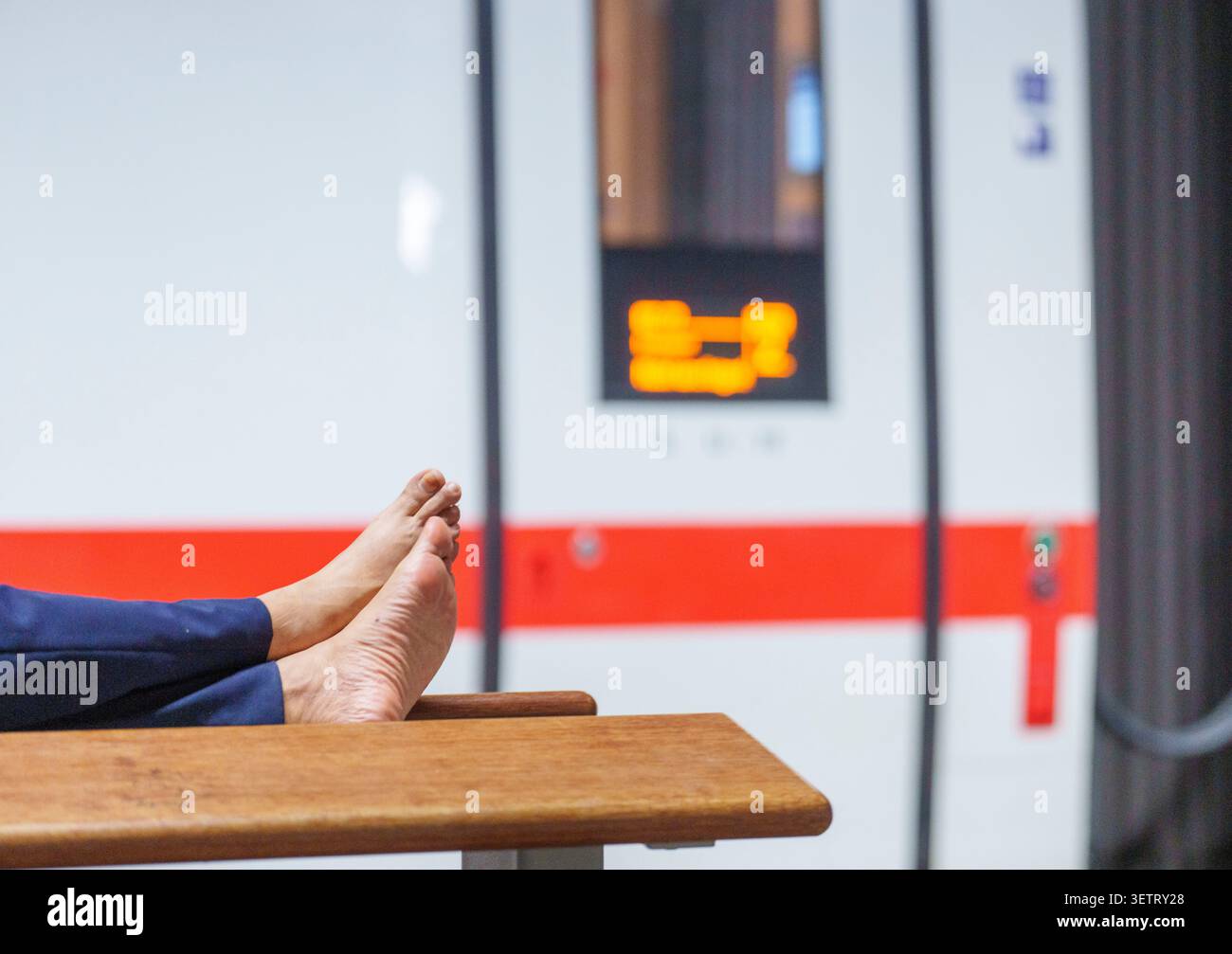 A commuter stretches out on a bench at Frankfurt's main station ...