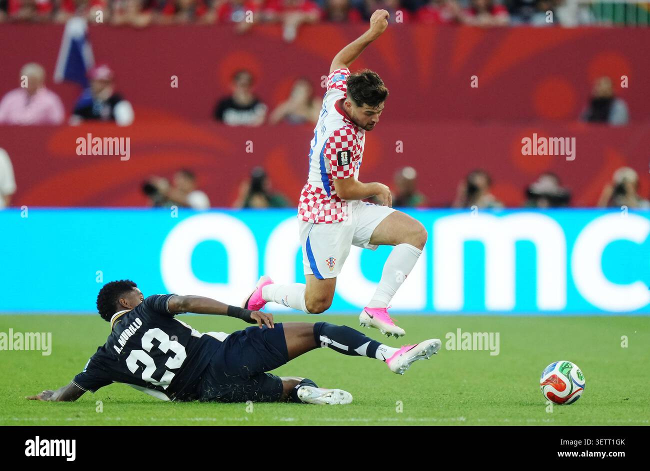Croatia's Martin Baturina (16) leaps over Panama's Michael Amir Murillo ...
