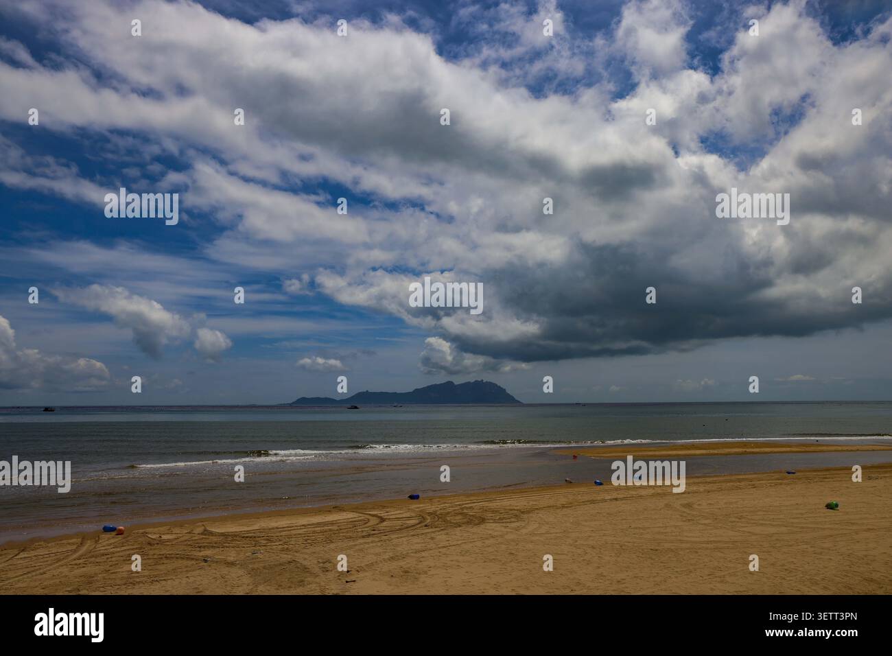 Tourists stroll along the shoreline of Lingshan Bay in Qingdao, east ...