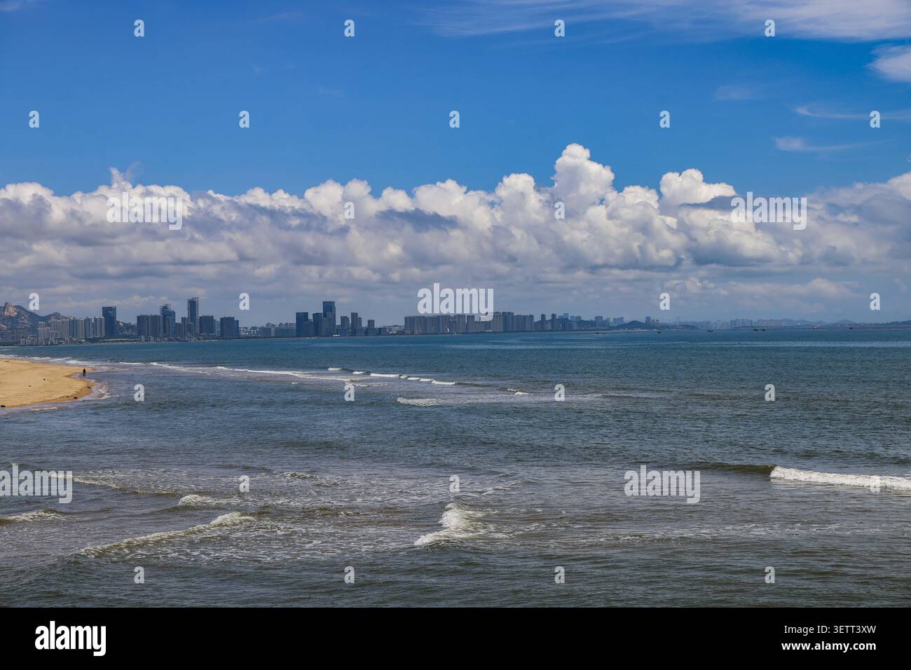 Tourists stroll along the shoreline of Lingshan Bay in Qingdao, east ...