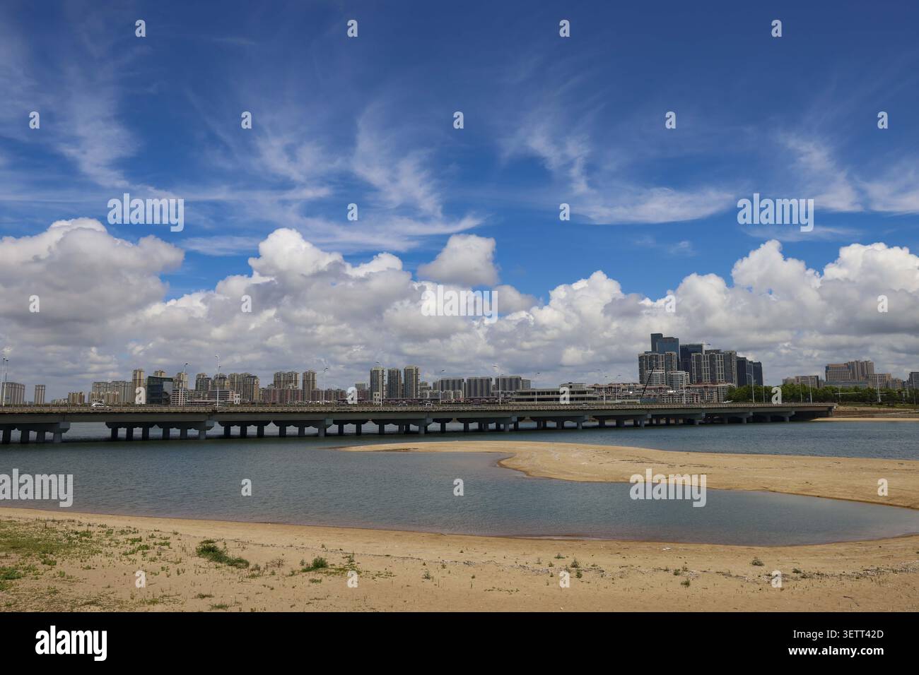 Tourists stroll along the shoreline of Lingshan Bay in Qingdao, east ...