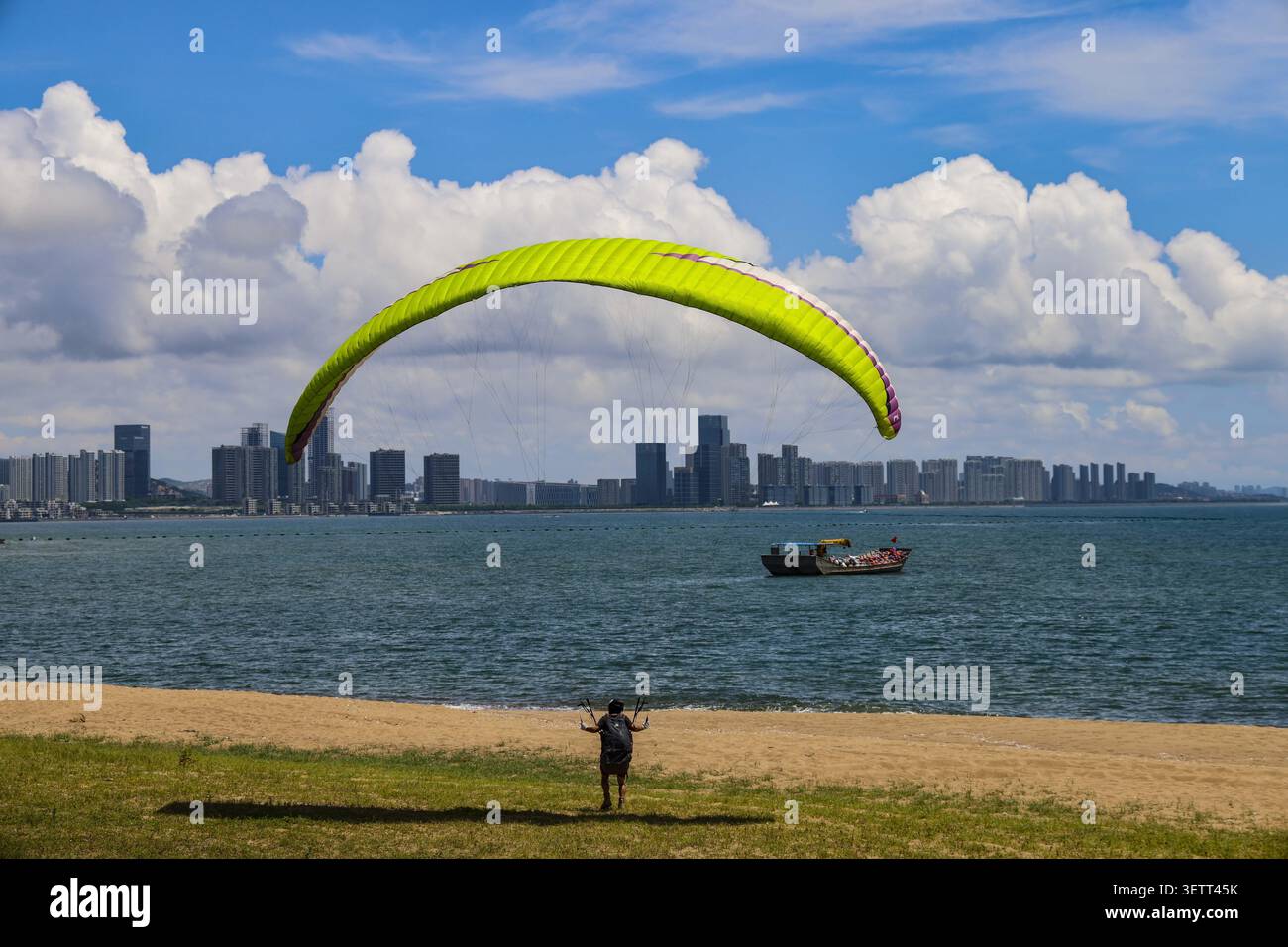 Tourists stroll along the shoreline of Lingshan Bay in Qingdao, east ...