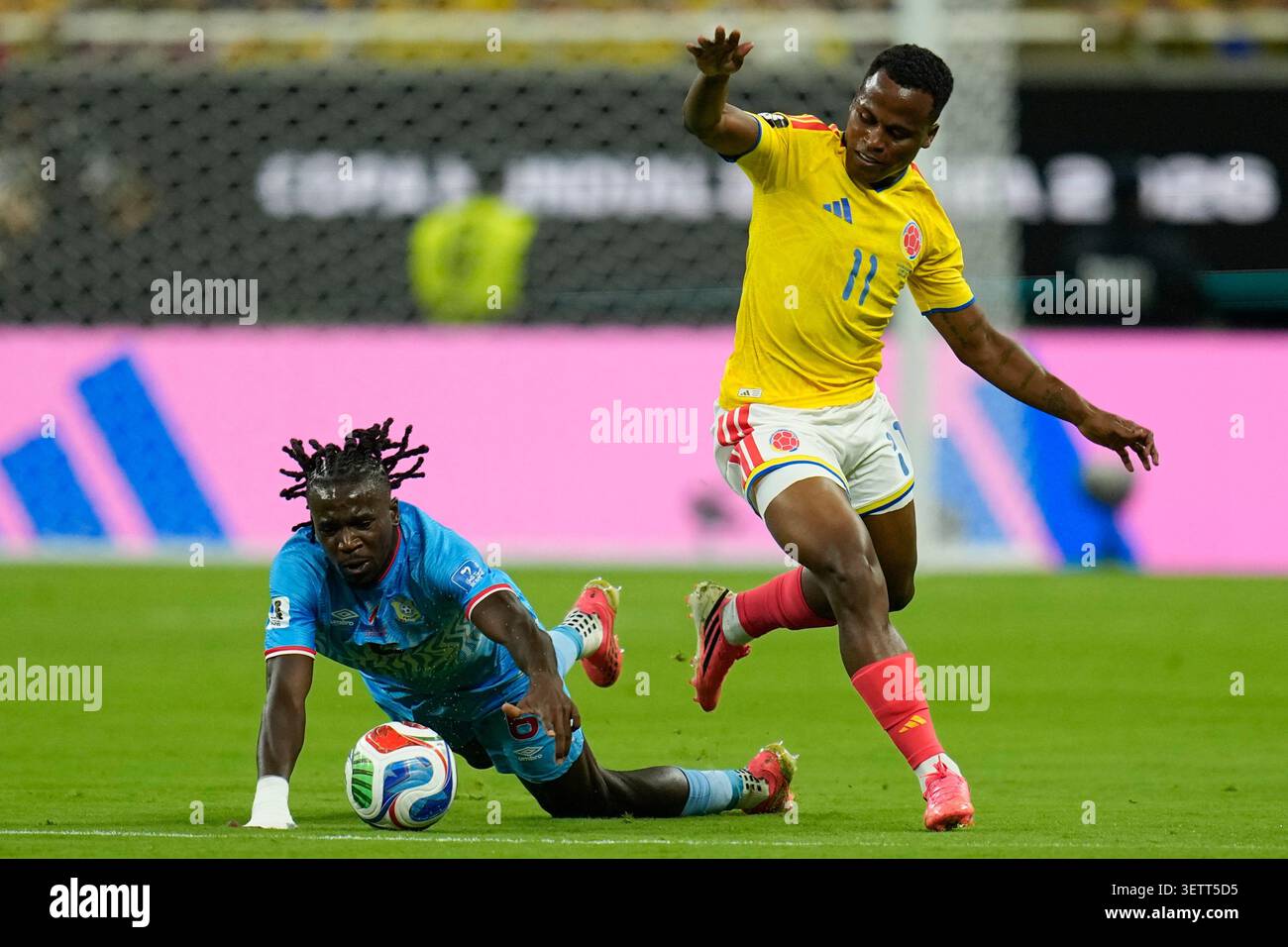Congo's Ngalayel Mukau falls to the ground in a clash with Colombia's ...