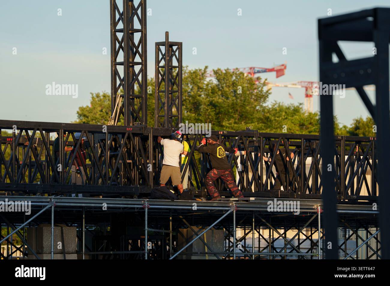 Workers build the stage for the July 4th Salute to America Celebration ...