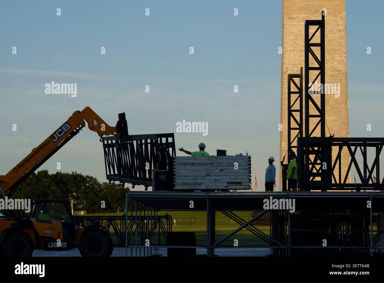 Workers build the stage for the July 4th Salute to America Celebration ...