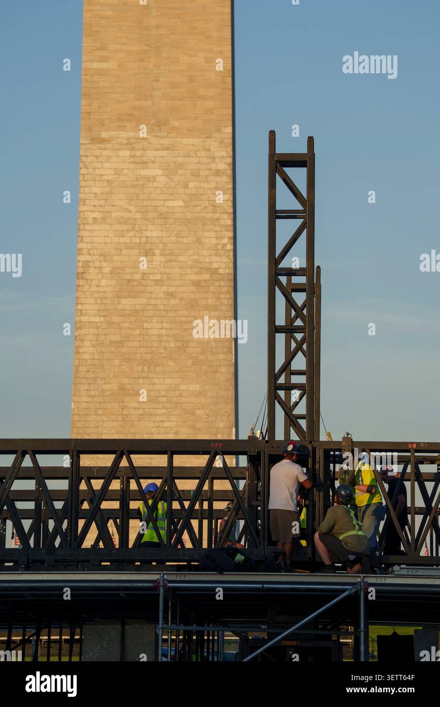 Workers build the stage for the July 4th Salute to America Celebration ...