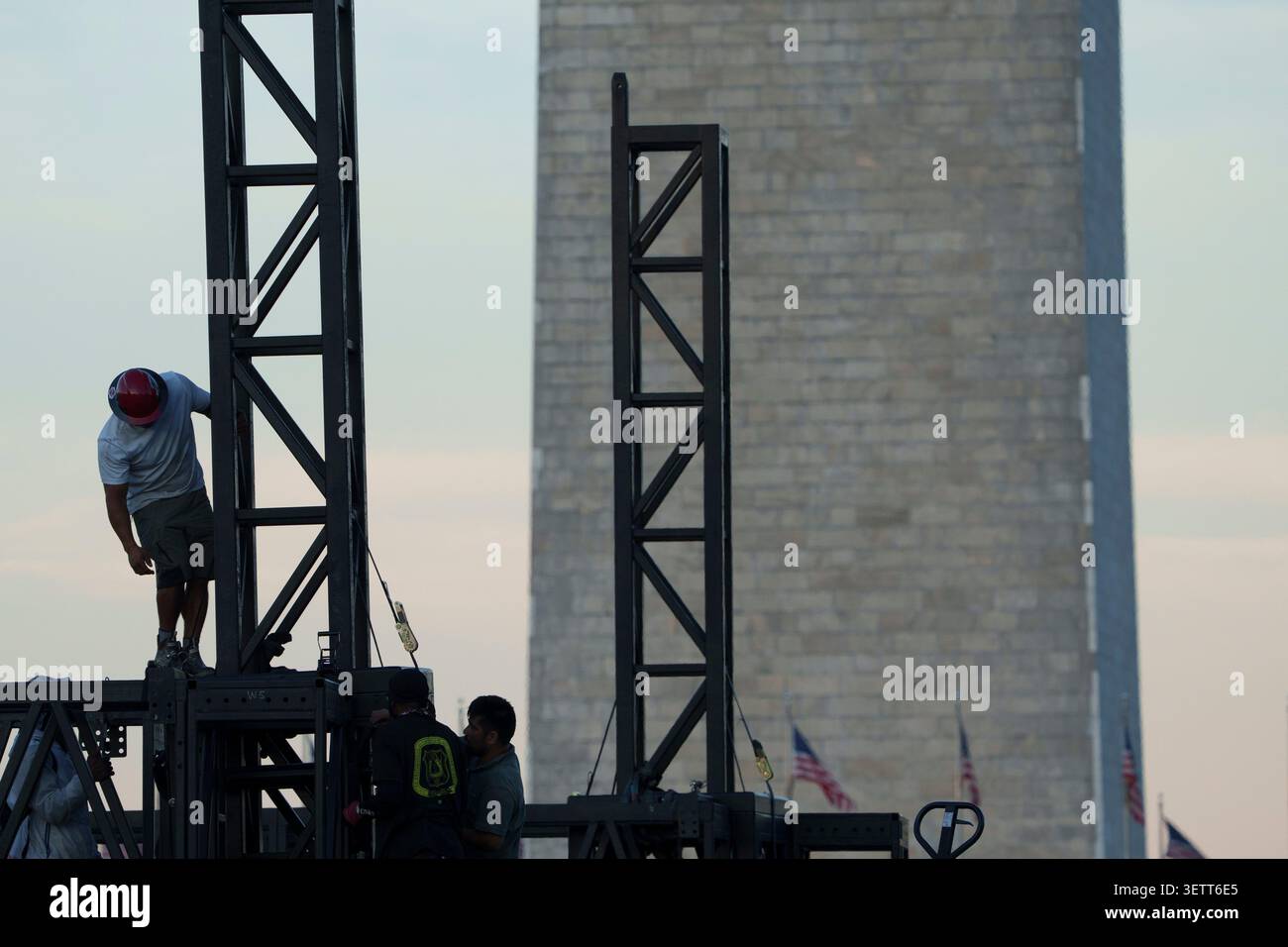 Workers build the stage for the July 4th Salute to America Celebration ...