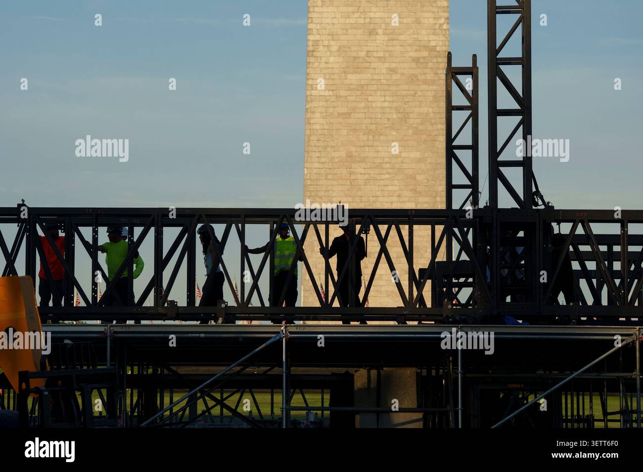 Workers build the stage for the July 4th Salute to America Celebration ...