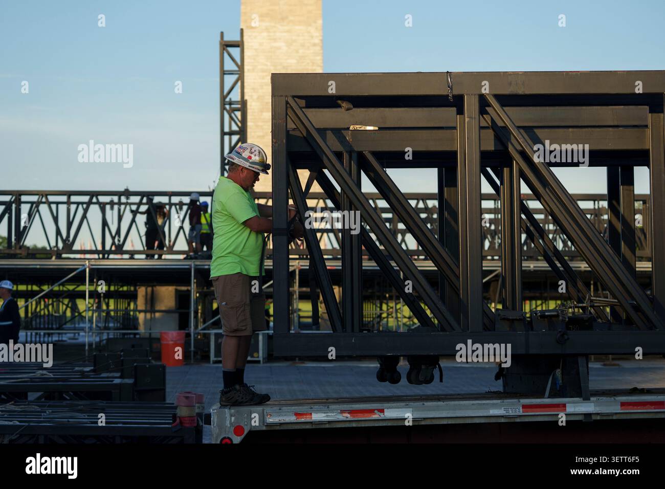 Workers build the stage for the July 4th Salute to America Celebration ...