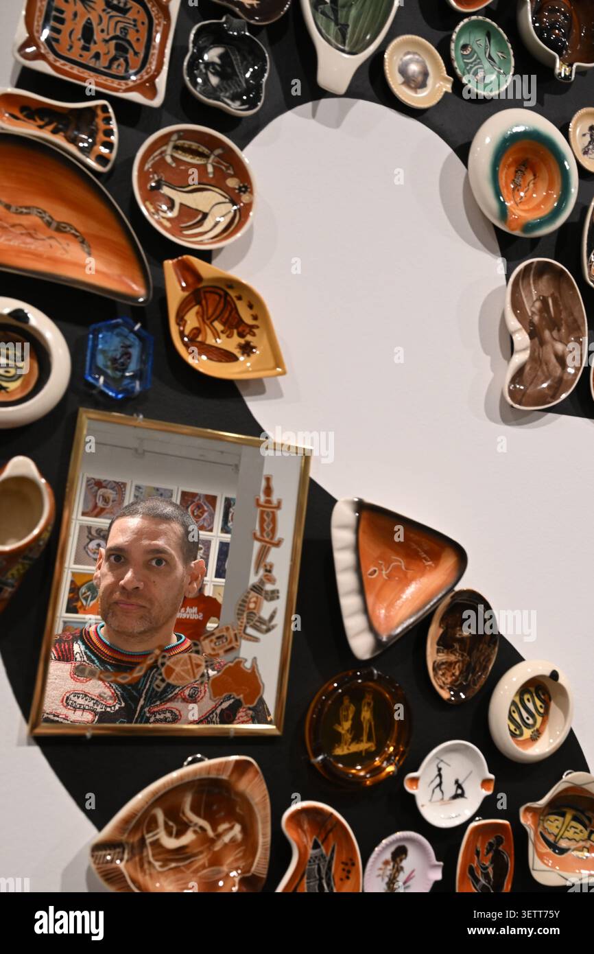Artist Tony Albert is seen reflected in a mirror in his piece titled ...
