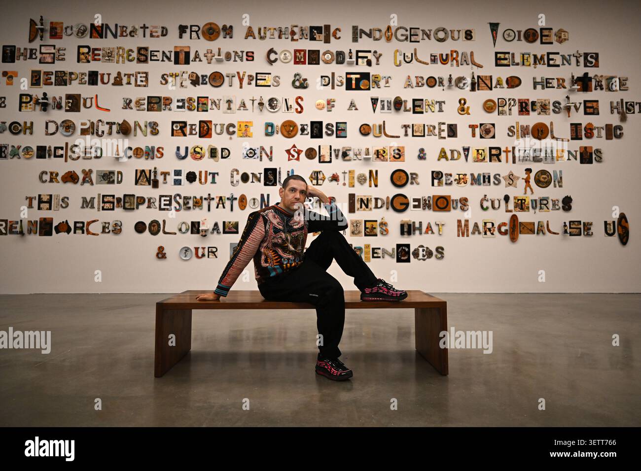 Artist Tony Albert poses for a photo in front of his work ‘Disconnected ...