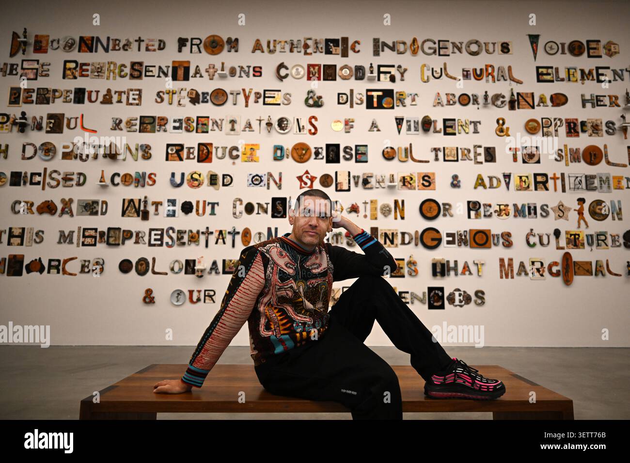 Artist Tony Albert poses for a photo in front of his work ‘Disconnected ...