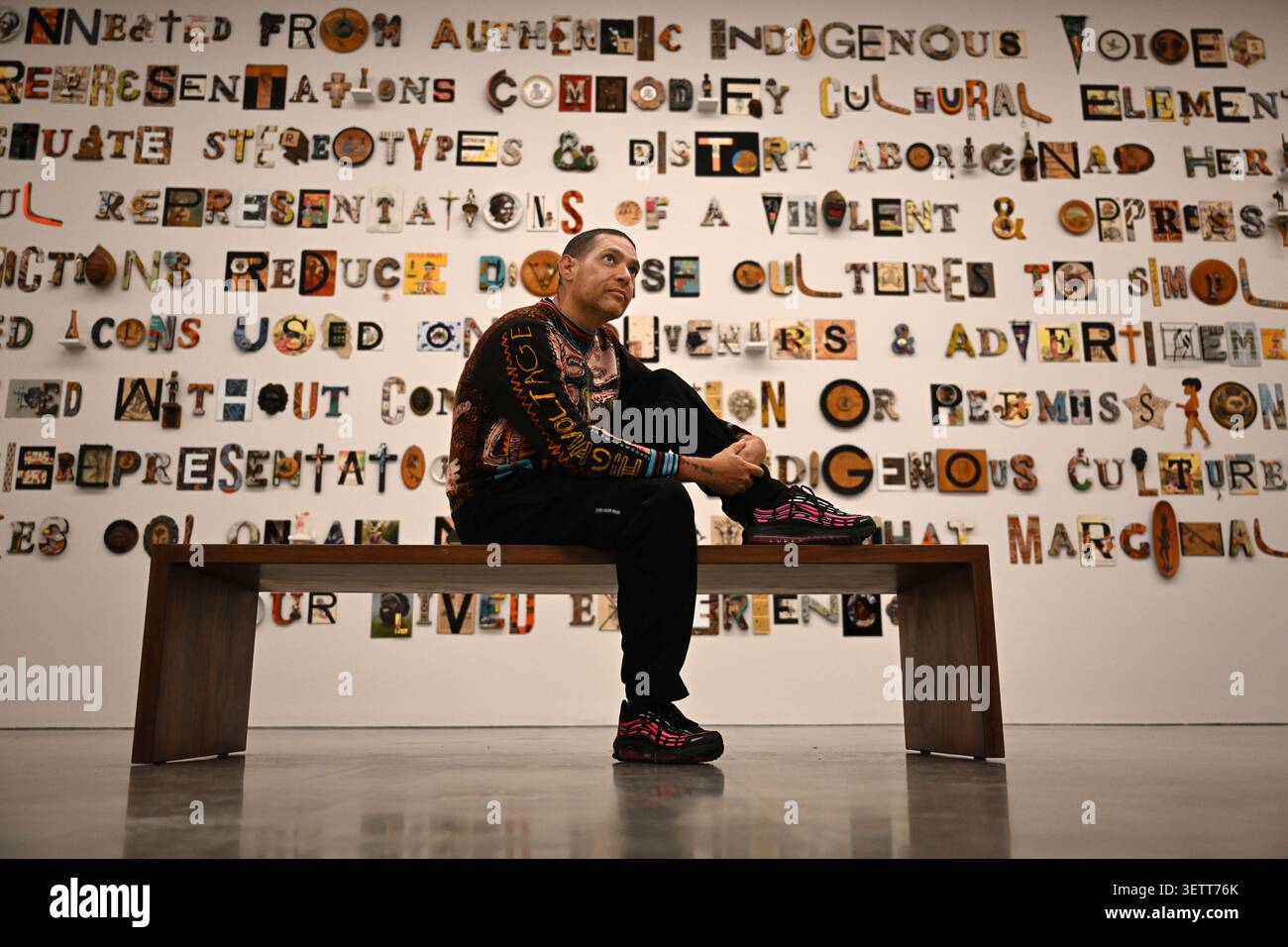 Artist Tony Albert poses for a photo in front of his work ‘Disconnected ...