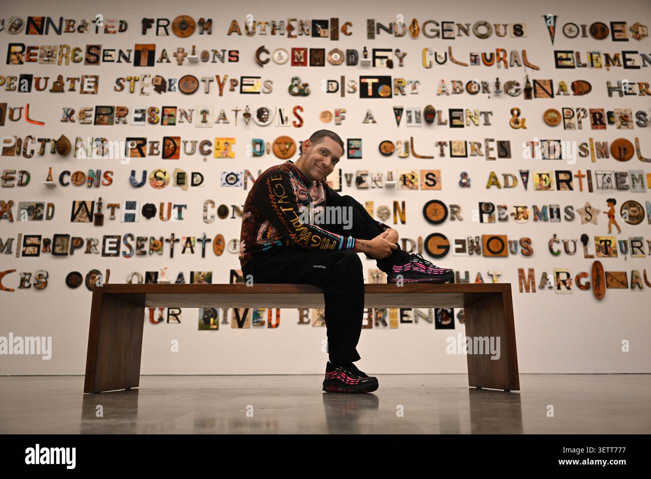 Artist Tony Albert poses for a photo in front of his work ‘Disconnected ...