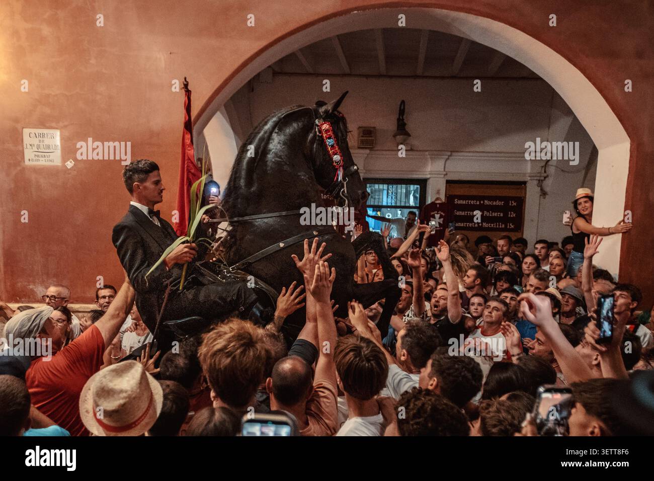 Ciutadella, Spain. 23 June, 2026: A 'caixer' (horse rider) enters up on ...