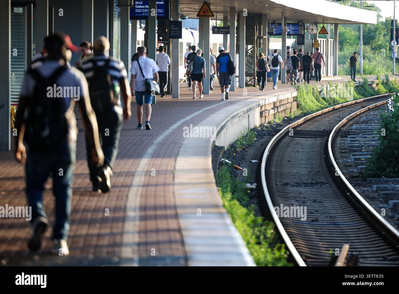 24 June 2026, North Rhine-Westphalia, Duisburg: Travelers walk along a ...