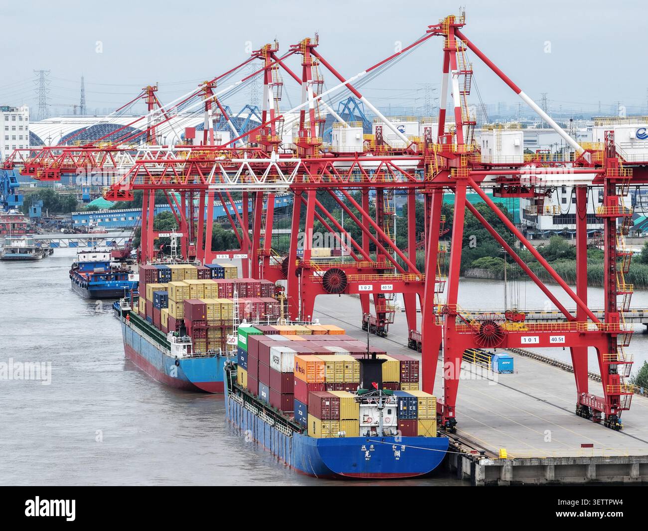 Containers are loaded and unloaded at Yangzhou Port in east China's ...