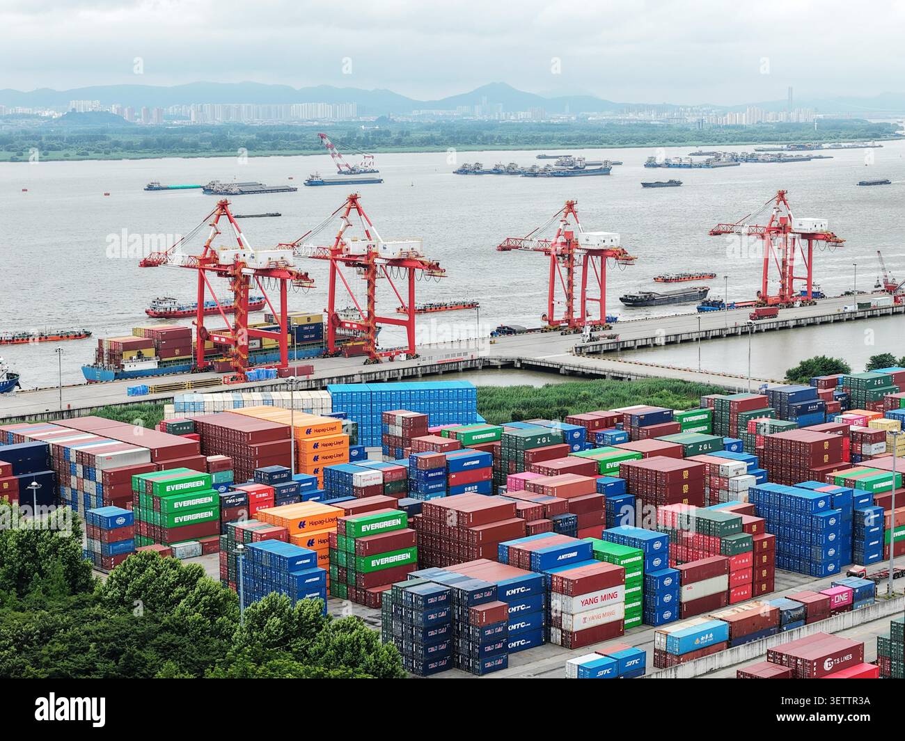 Containers are loaded and unloaded at Yangzhou Port in east China's ...