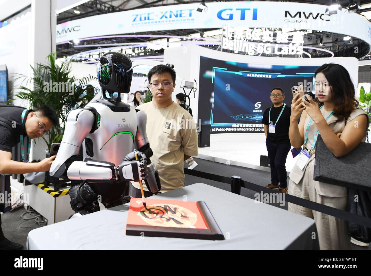 SHANGHAI, CHINA - JUNE 24, 2026 - An AgiBot writes the word 'fu' for ...