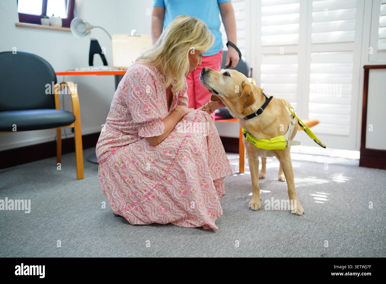 The Duchess of Edinburgh meeting a guide dog during a visit to EYECAN ...
