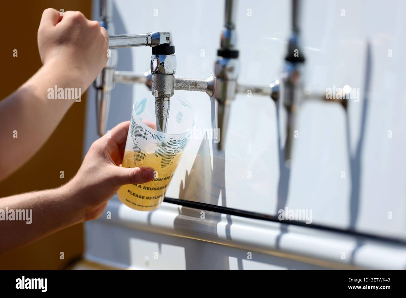 Spectators pull a drink of beer on day three of the Lexus Eastbourne ...