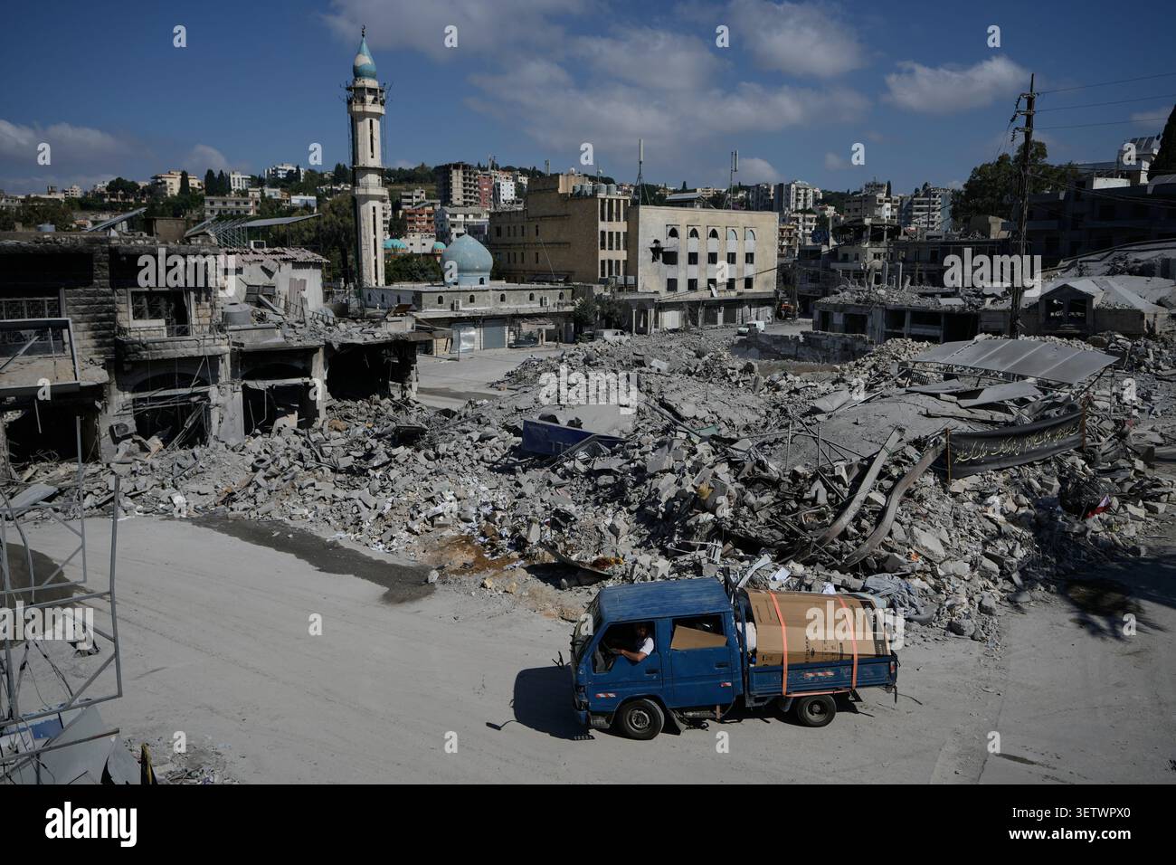 Returning residents drive past buildings destroyed in previous Israeli ...