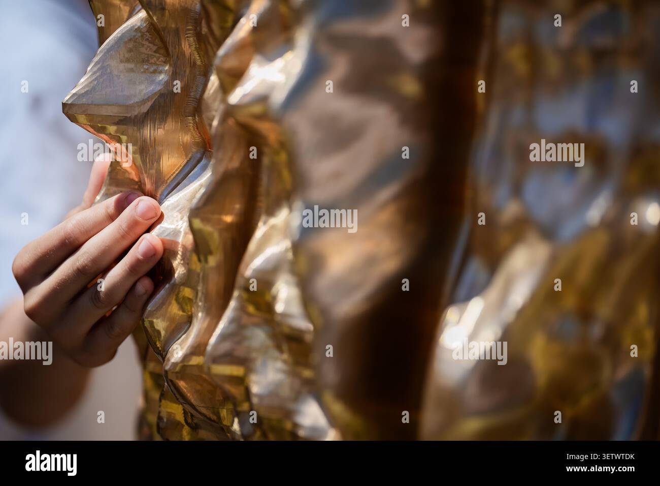 24 June 2026, Berlin: During its dedication ceremony, a person touches ...