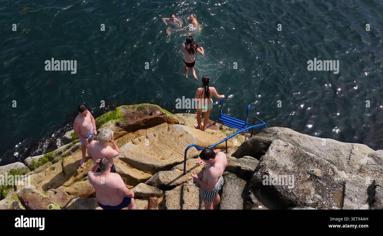 People cooling off at the Forty Foot bathing place at Sandycove in ...