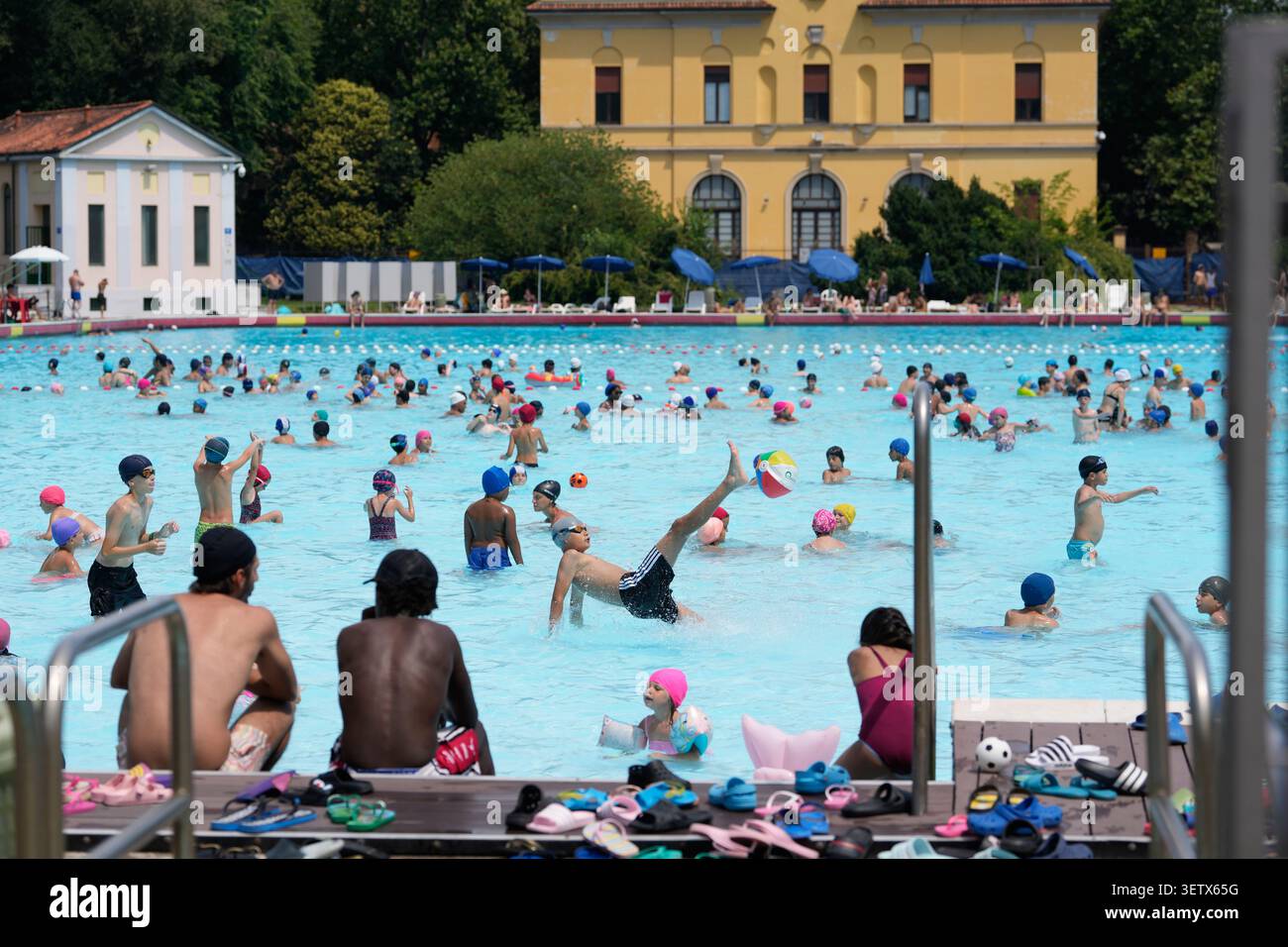 People cool off at the Piscina Romano as a heat wave is predicted ...
