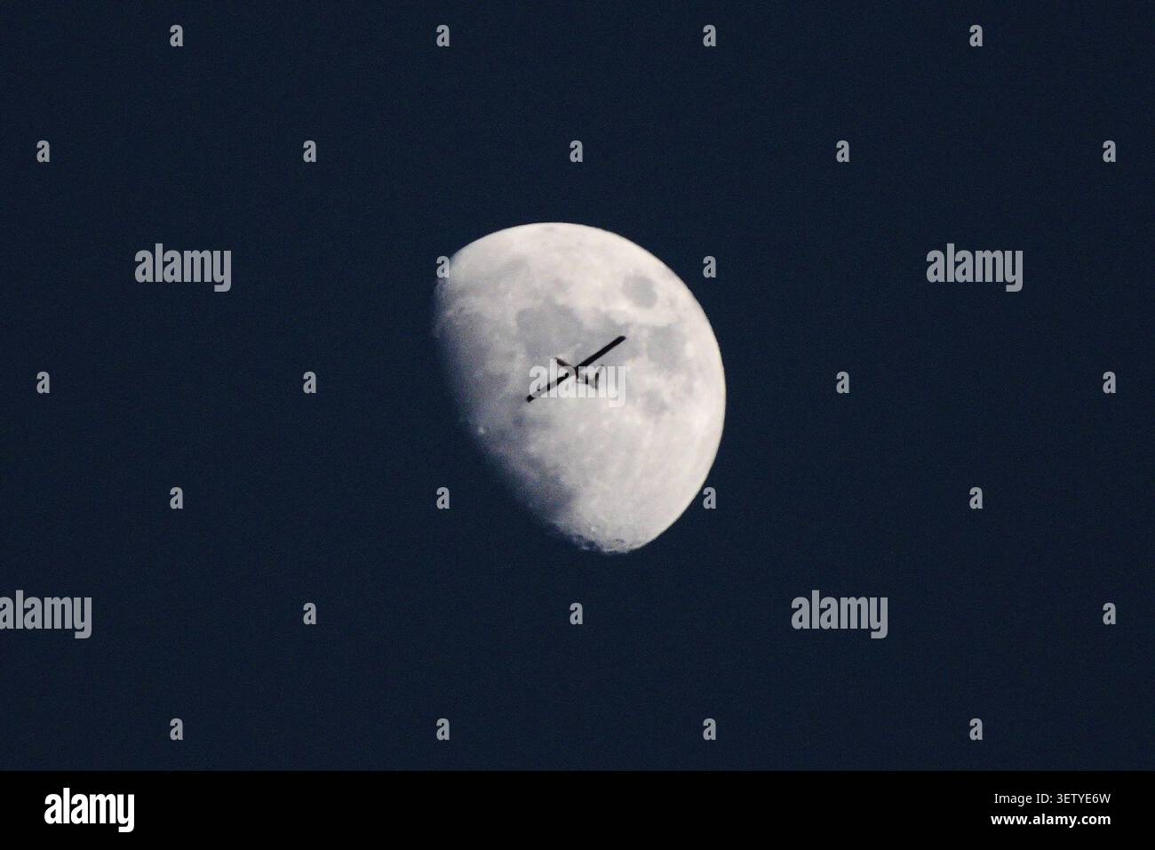 An Israeli drone is silhouetted against the moon as it flies over ...