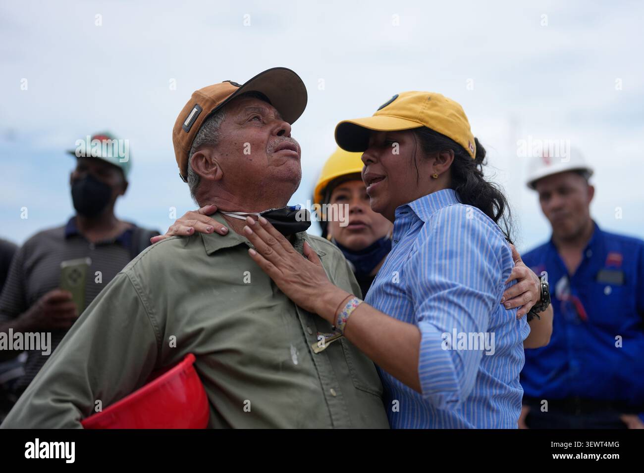 Relatives of Jesus Guedes wait outside their earthquake-damaged home ...