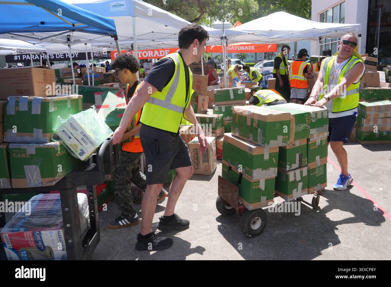 Volunteers push donated items at the Global Empowerment Mission ...