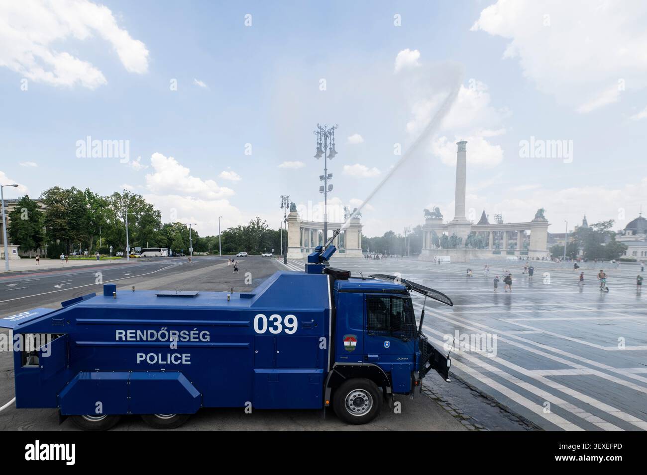 A police water cannon sprays a cooling mist over passersby in Heroes ...