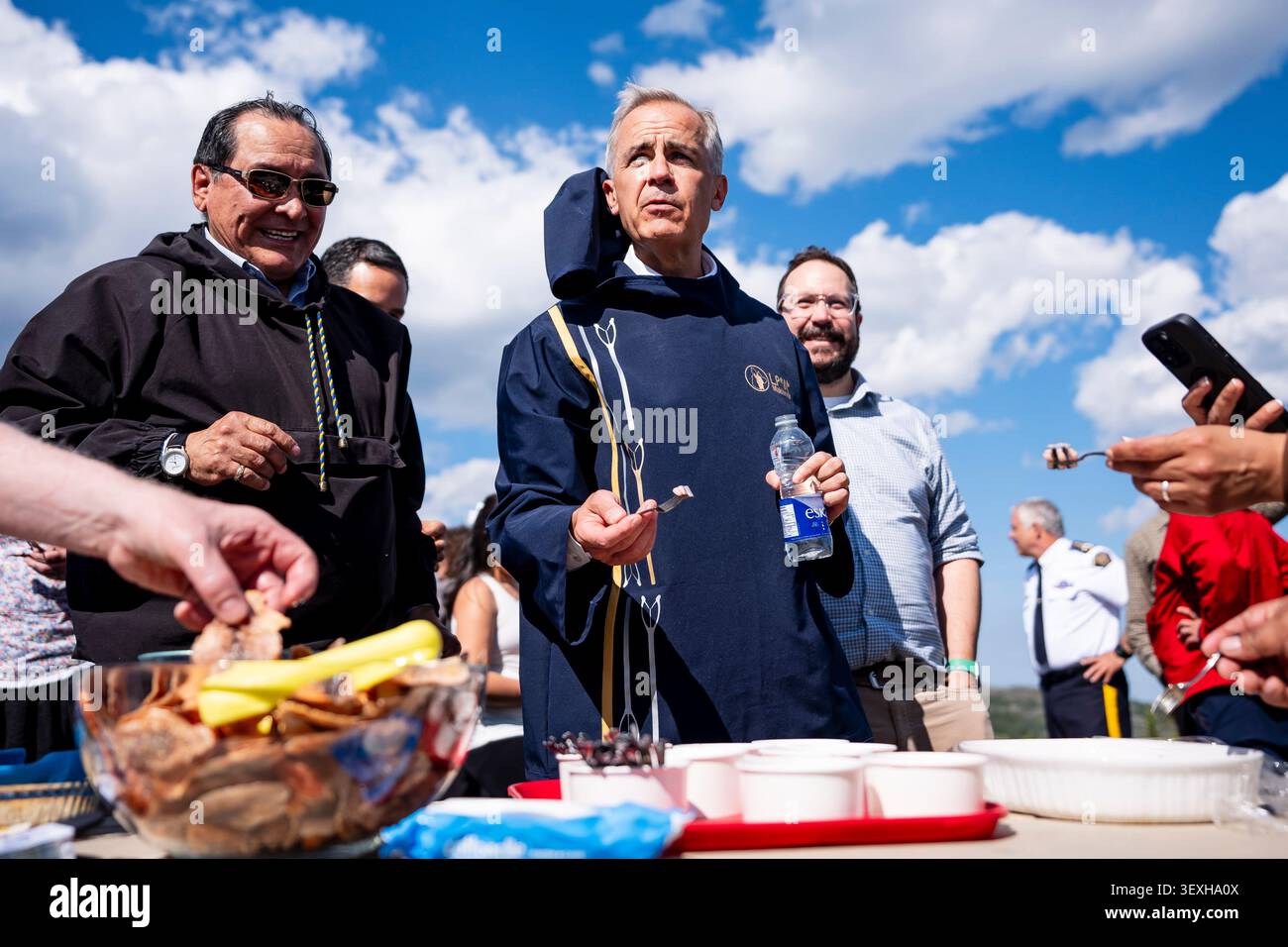 Prime Minister Mark Carney eats baby beluga during an event in Kuujjuaq ...