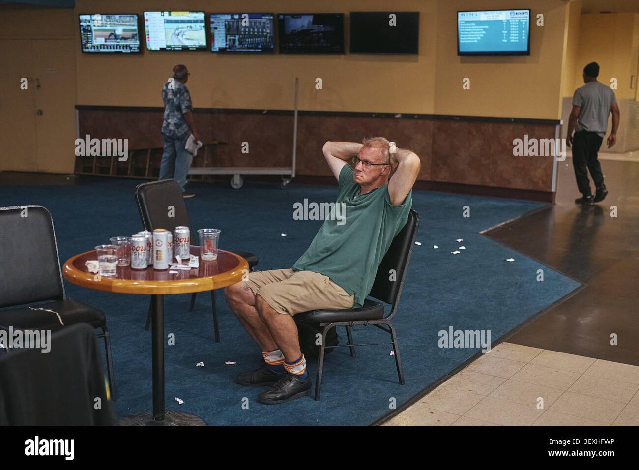A man watches the races inside Aqueduct Racetrack in the Queens borough ...