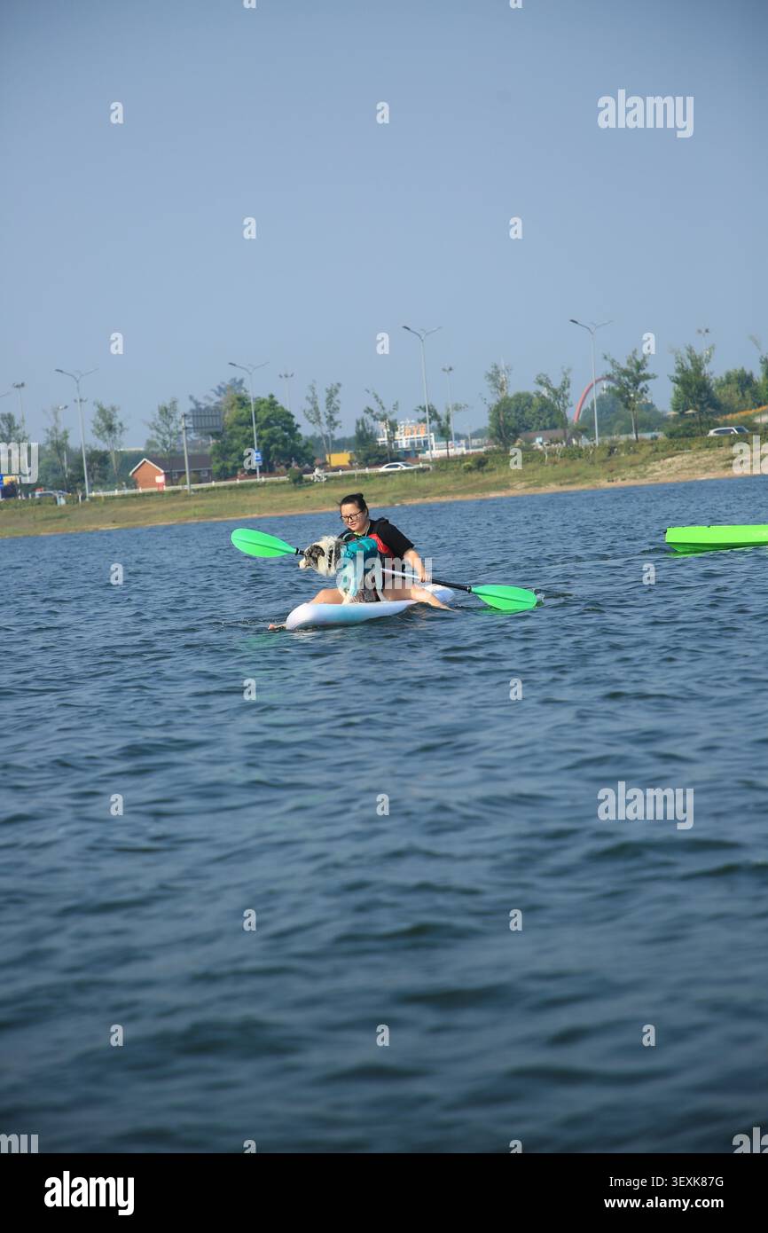 Tourists try paddleboarding and kayaking at the Olympic Water Park in ...