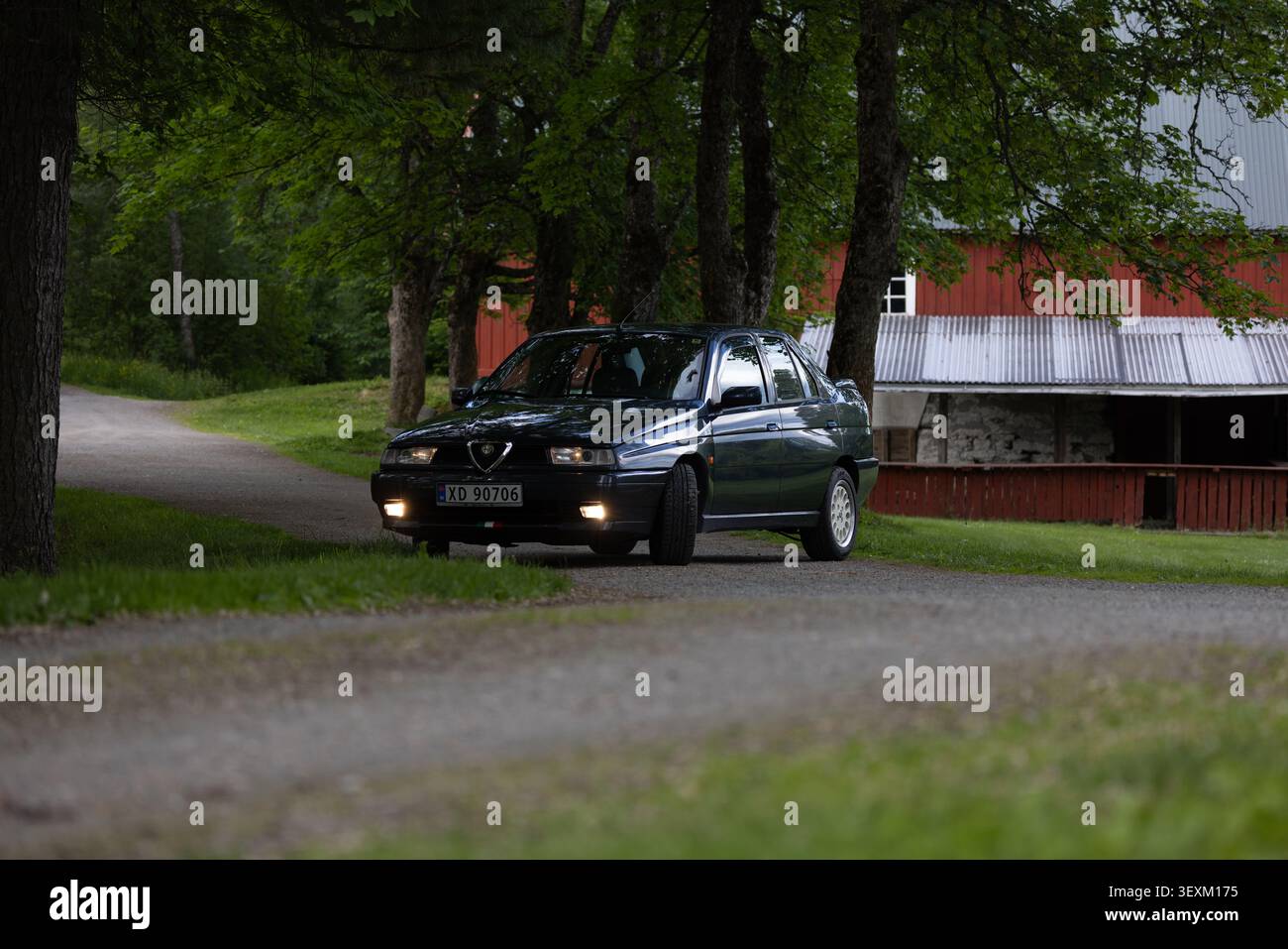 Steinkjer, Norway - June 15th 2024 - Dark Alfa Romeo 155 glides along ...