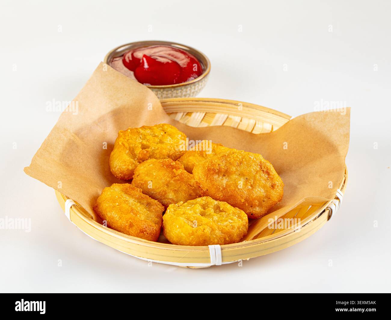 Crispy golden fried snack bites served in bamboo basket lined with ...