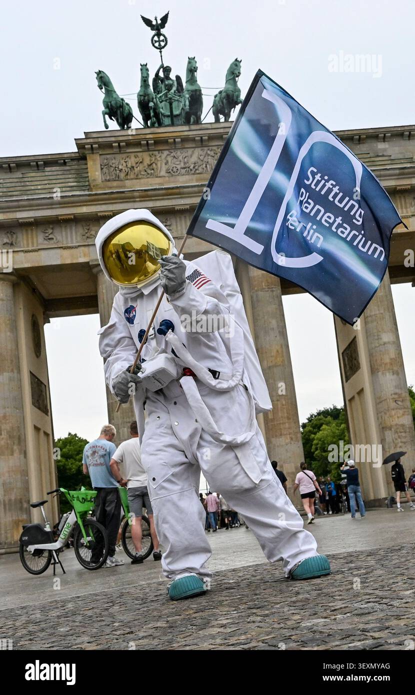 01 July 2026, Berlin: An actress dressed as an astronaut stands in ...