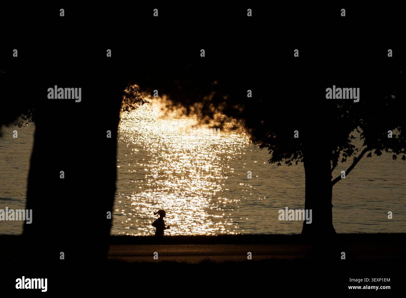A person jogs along the Potomac River Wednesday, July 1, 2026, in ...