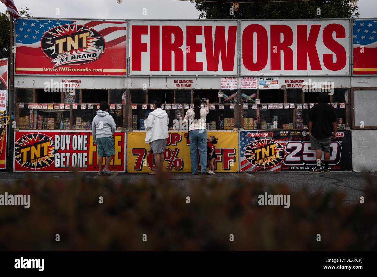 People purchase fireworks at a TNT Fireworks stand in Alhambra, Calif ...