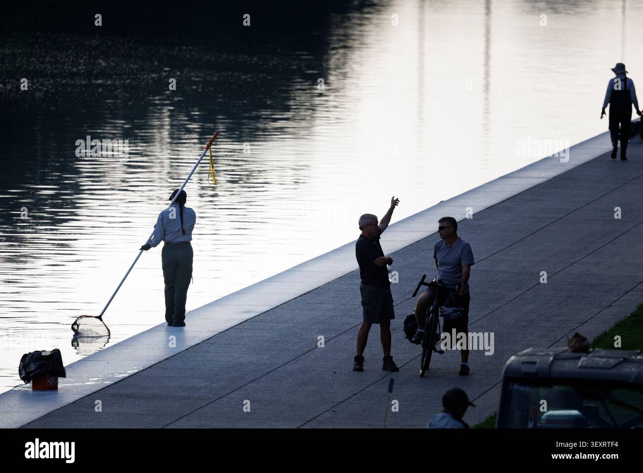 A worker clears debris from the Lincoln Memorial Reflecting Pool ...