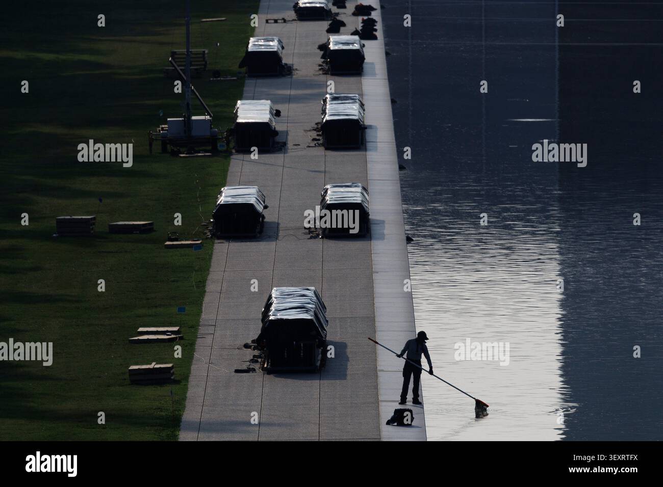 A worker clears debris from the Lincoln Memorial Reflecting Pool ...