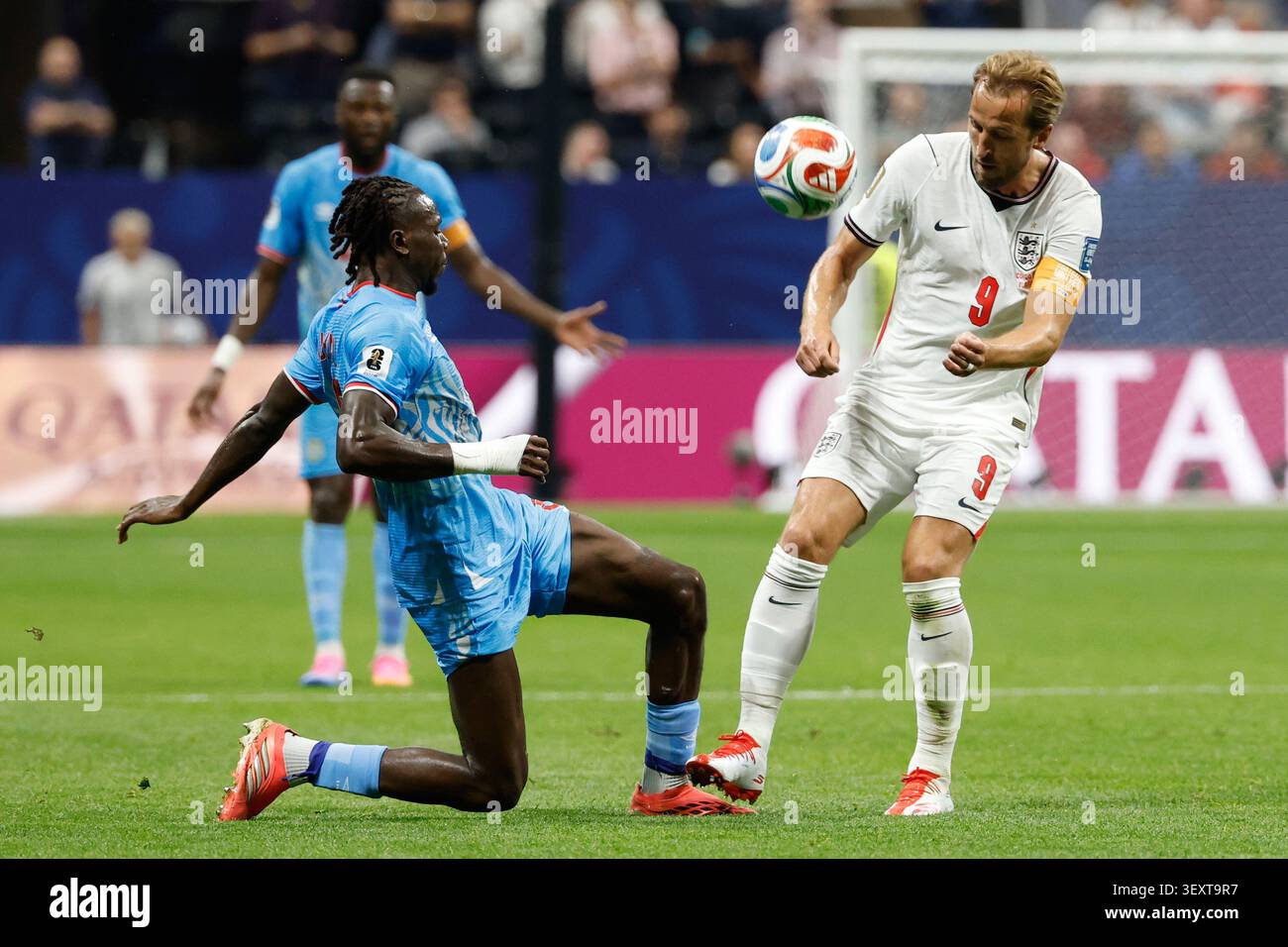 England's Harry Kane (9) and Congo's Ngalayel Mukau battle for the ball ...