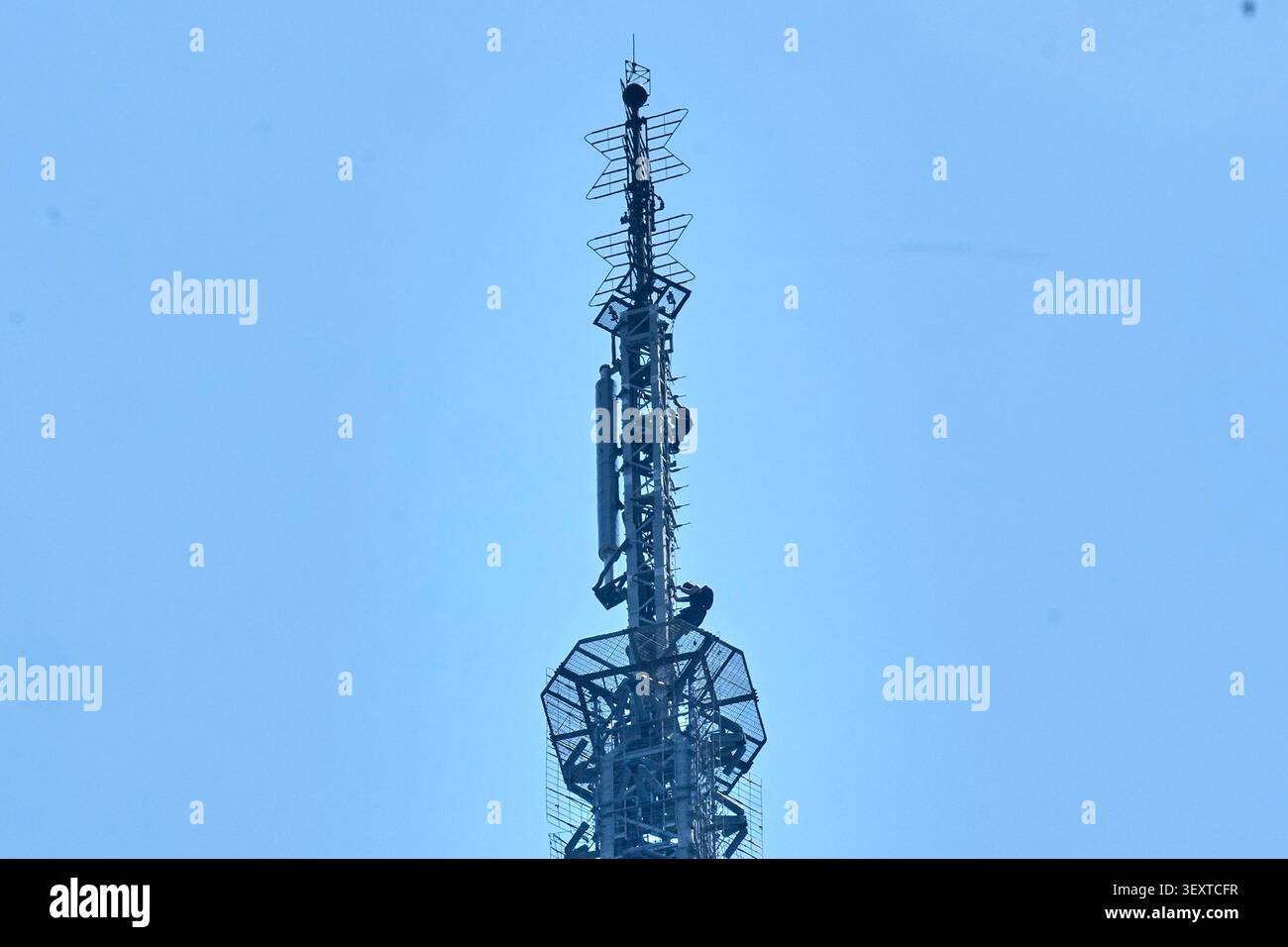 Two people descend the spire of the Empire State Building, in New York ...