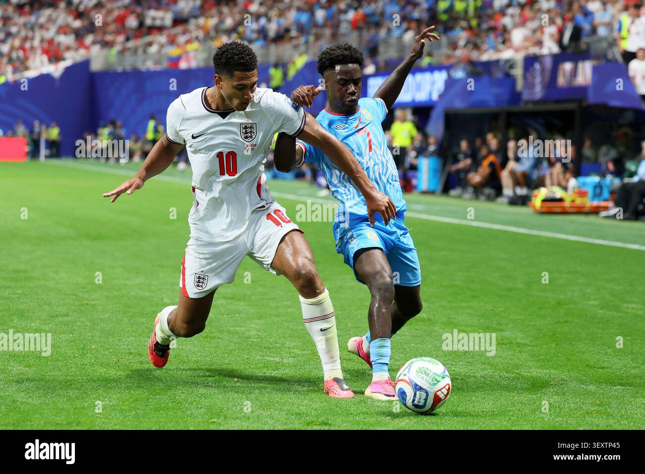 Jude Bellingham of England and Nathanael Mbuku of Congo DR challenge ...